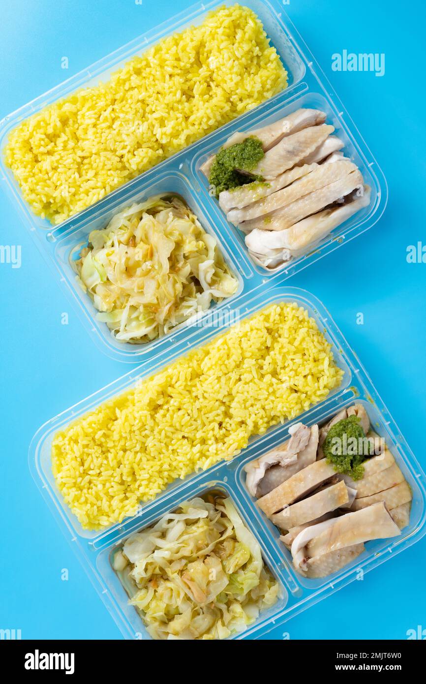 top view two packs of Hainanese chicken rice at vertical composition ...