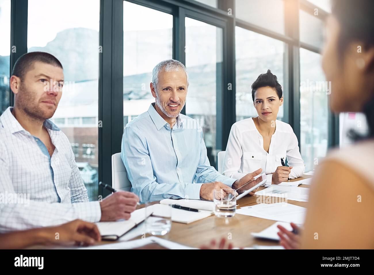 Everyone gives their all on this team. a group of coworkers talking ...