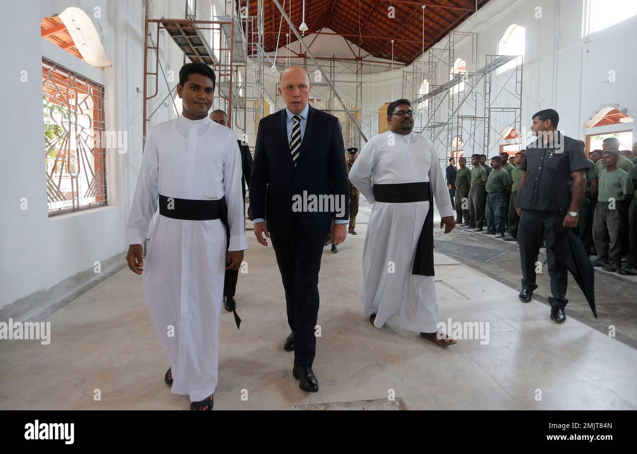 Australian Home Minister Peter Dutton, second left, talks with Catholic ...