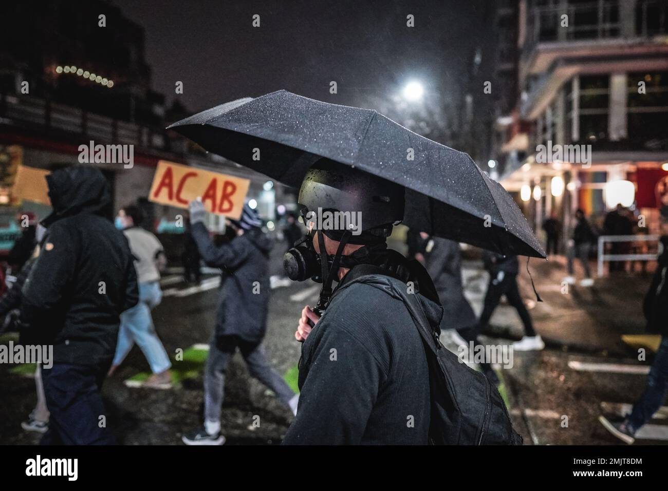 Protesters march through the streets while holding placards during the ...