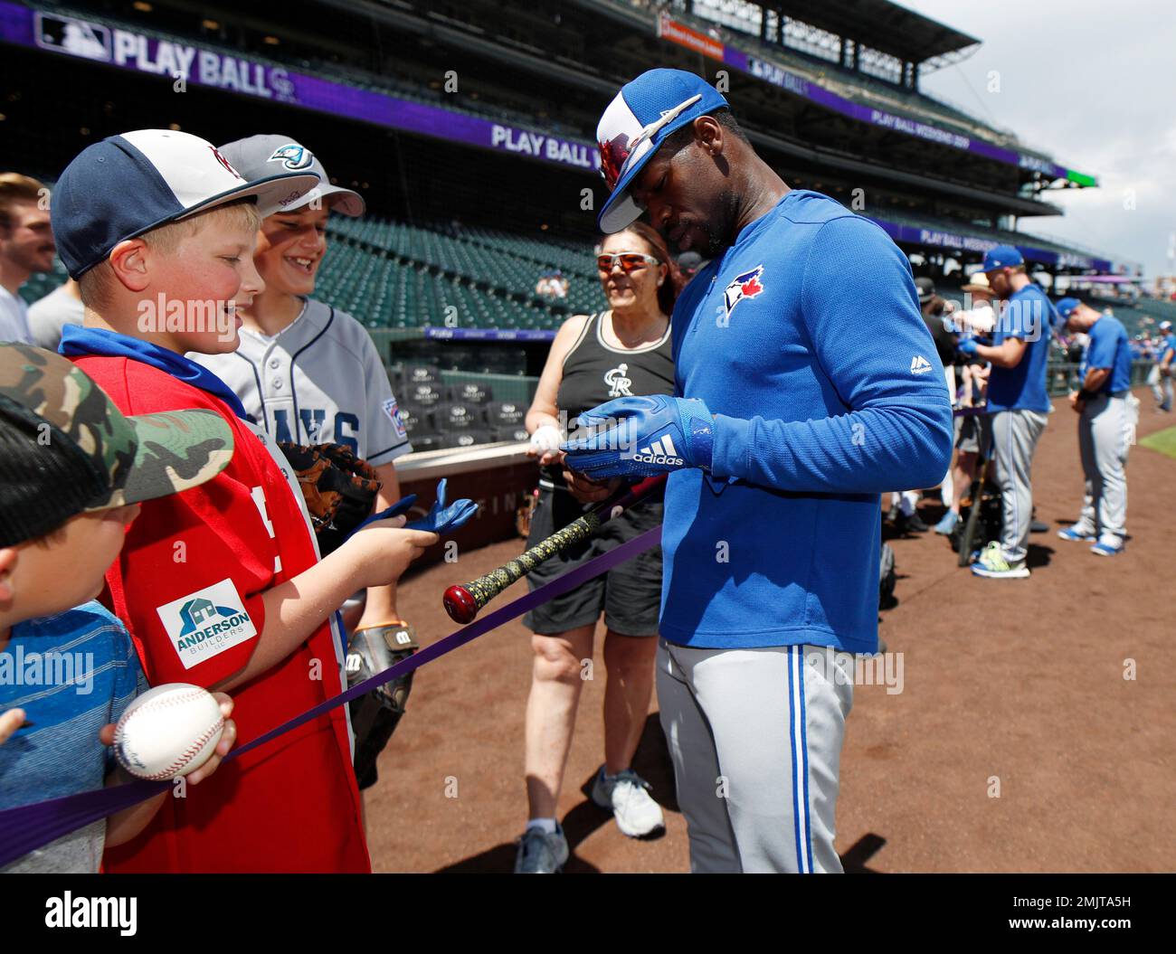 Toronto Blue Jays center fielder Jonathan Davis, right, hands a batting ...