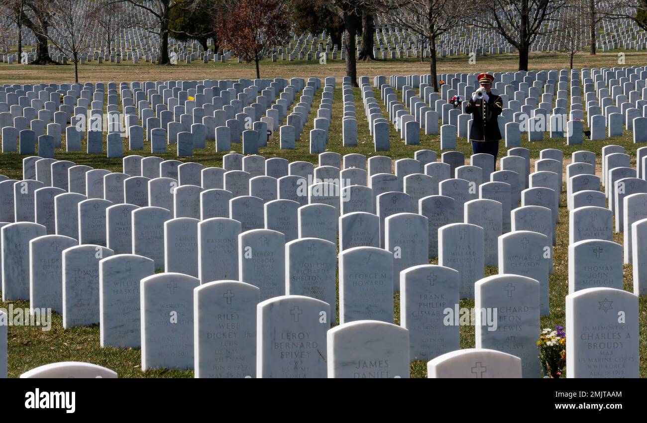 A military bugler plays taps during the funeral of LT. Colonel Richard ...