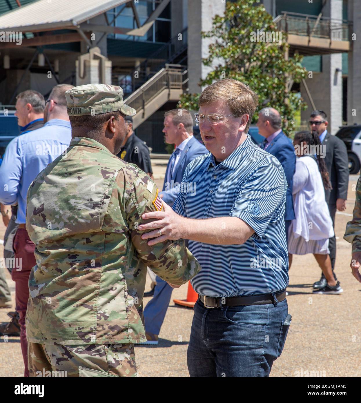 Mississippi Gov. Tate Reeves shakes hands with a Mississippi National ...