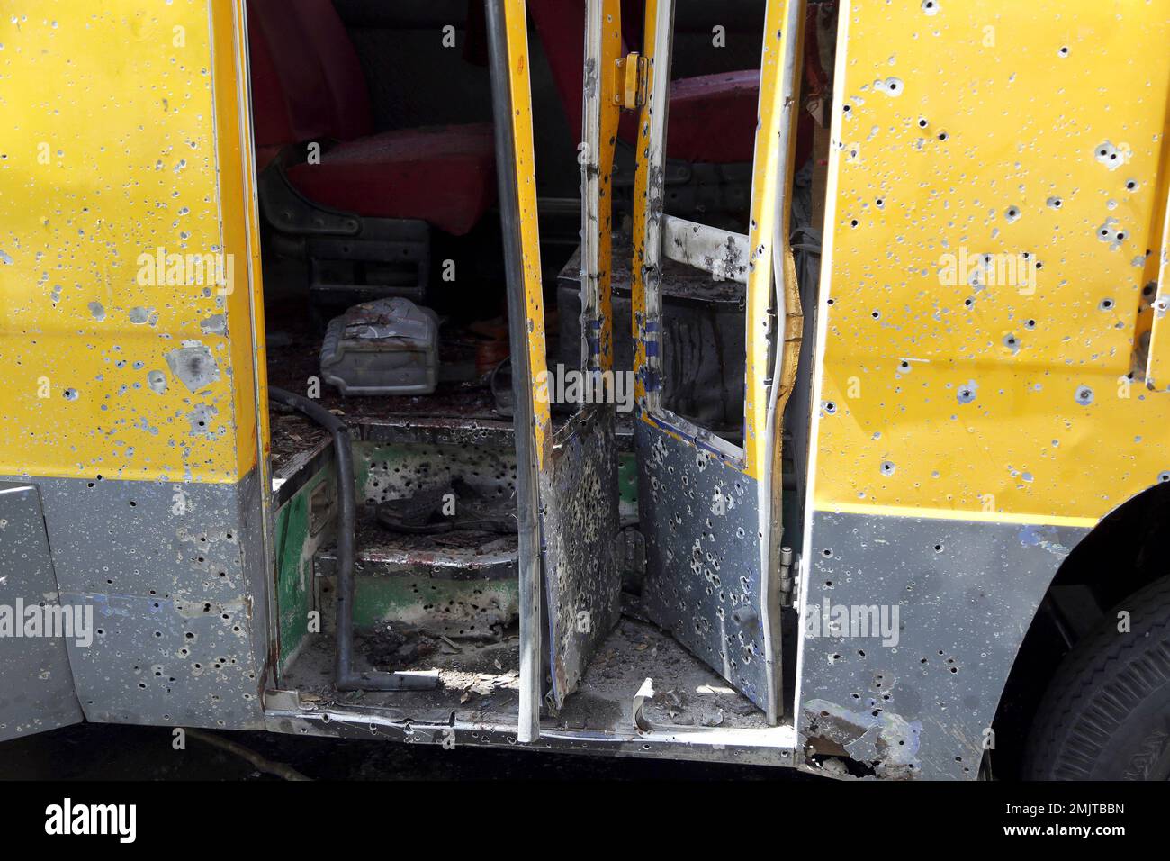 A damaged bus sits at the scene of an explosion in Kabul, Afghanistan ...