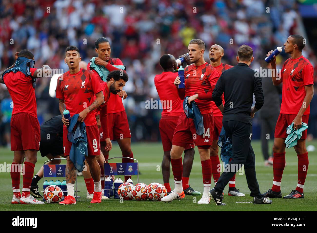 Liverpool players drink water after a warm-up before the Champions ...