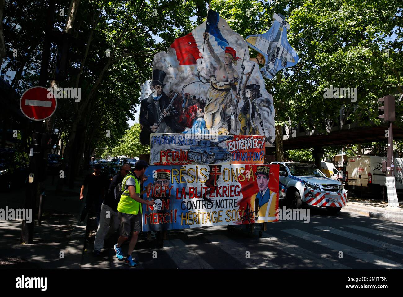 Yellow vest protestors push a giant banner referring to the "Liberty ...