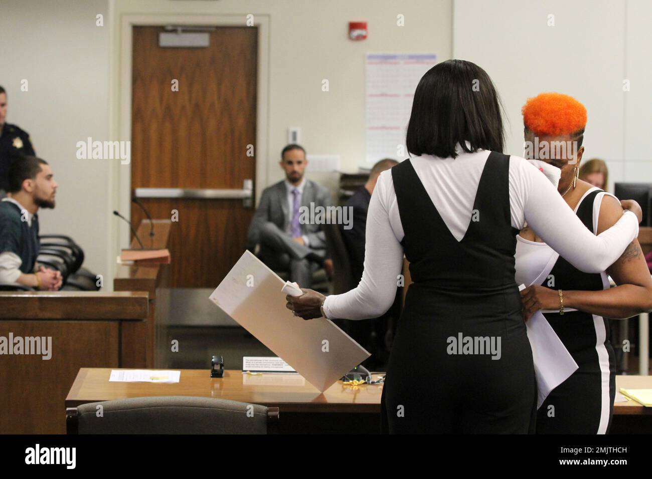Cecille Bennett Downy, left, consoles her sister Carol Bennett as she ...
