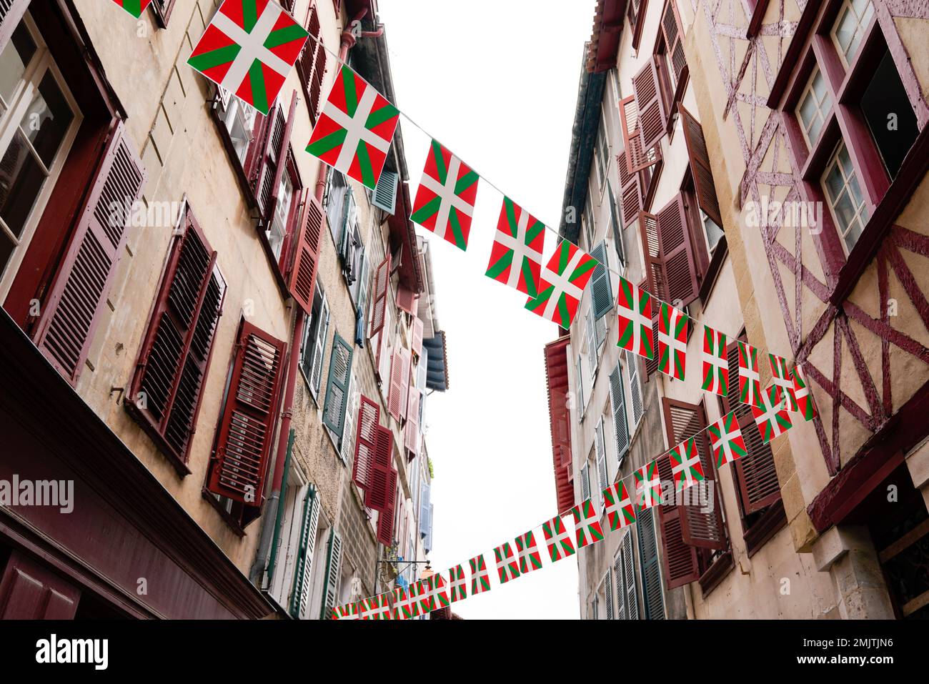 bask flag on facades of old houses basque in Bayonne France Stock Photo ...