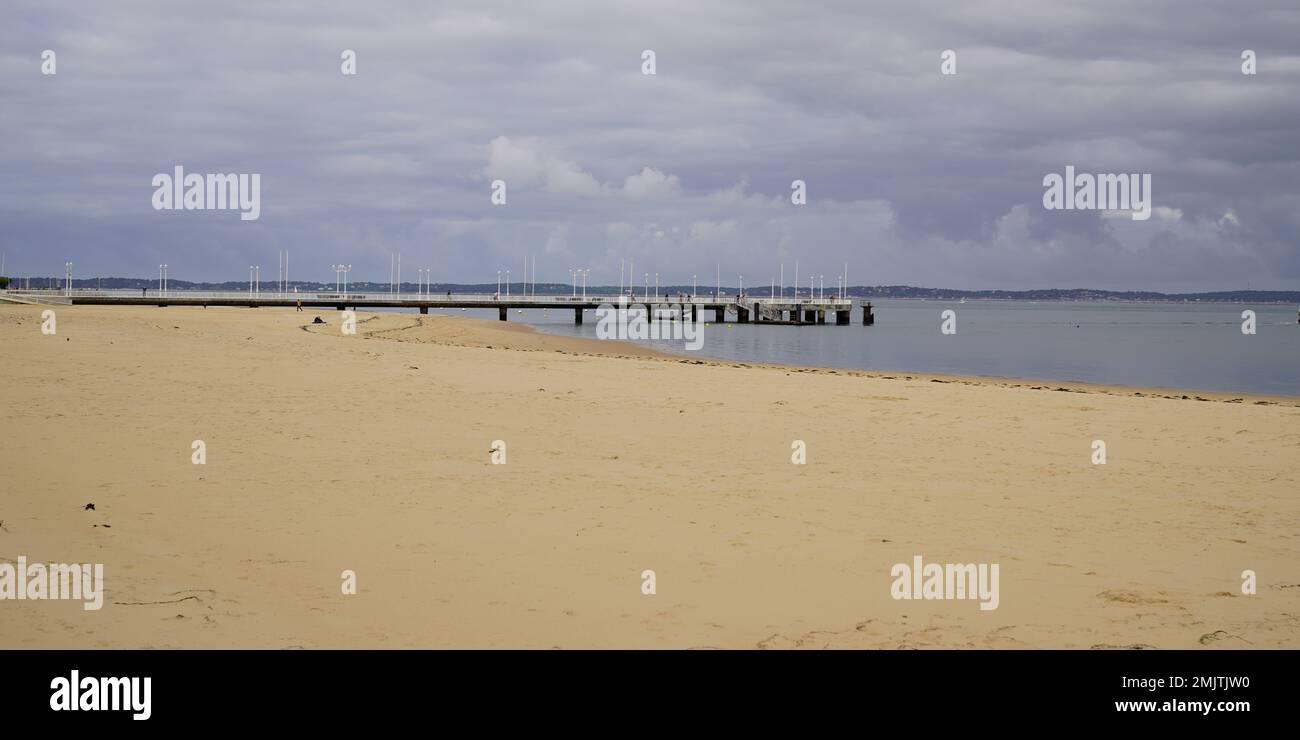 sand beach in low tide in arcachon bay pontoon Pier of Andernos les ...