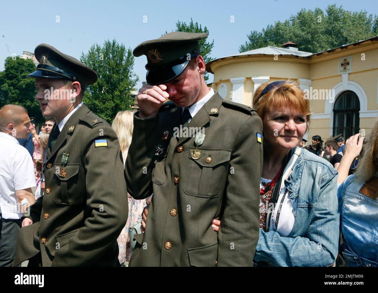 A graduate cadet wipes away tears after the graduation ceremony, at the ...