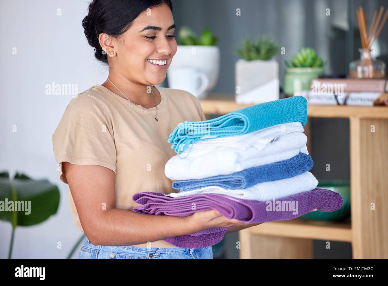 Laundry, housework and towels with a woman cleaner working in a home ...