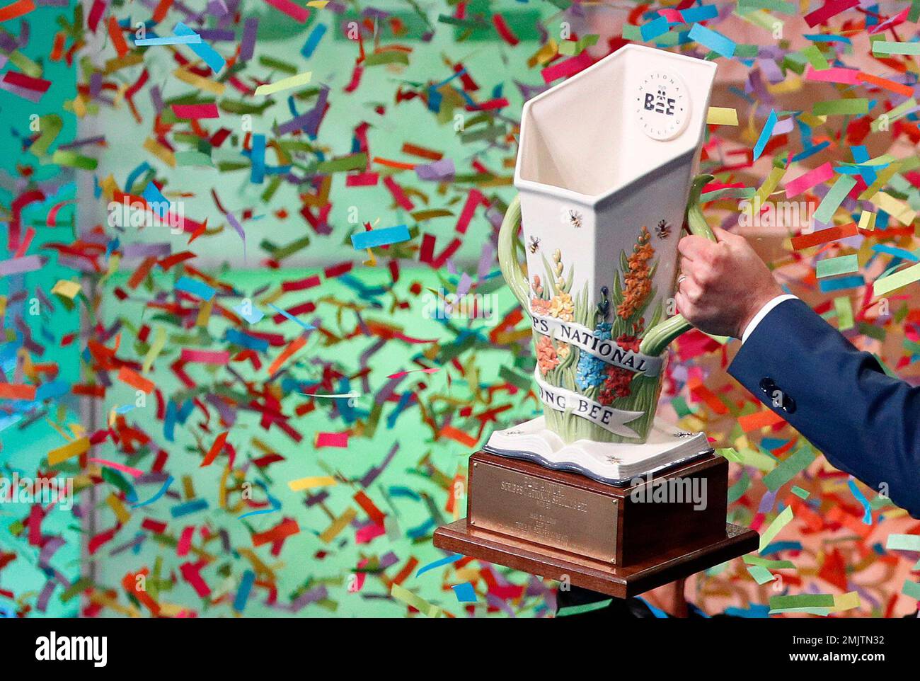 E.W. Scripps CEO Adam Symson carries a trophy for eight co-champions of ...