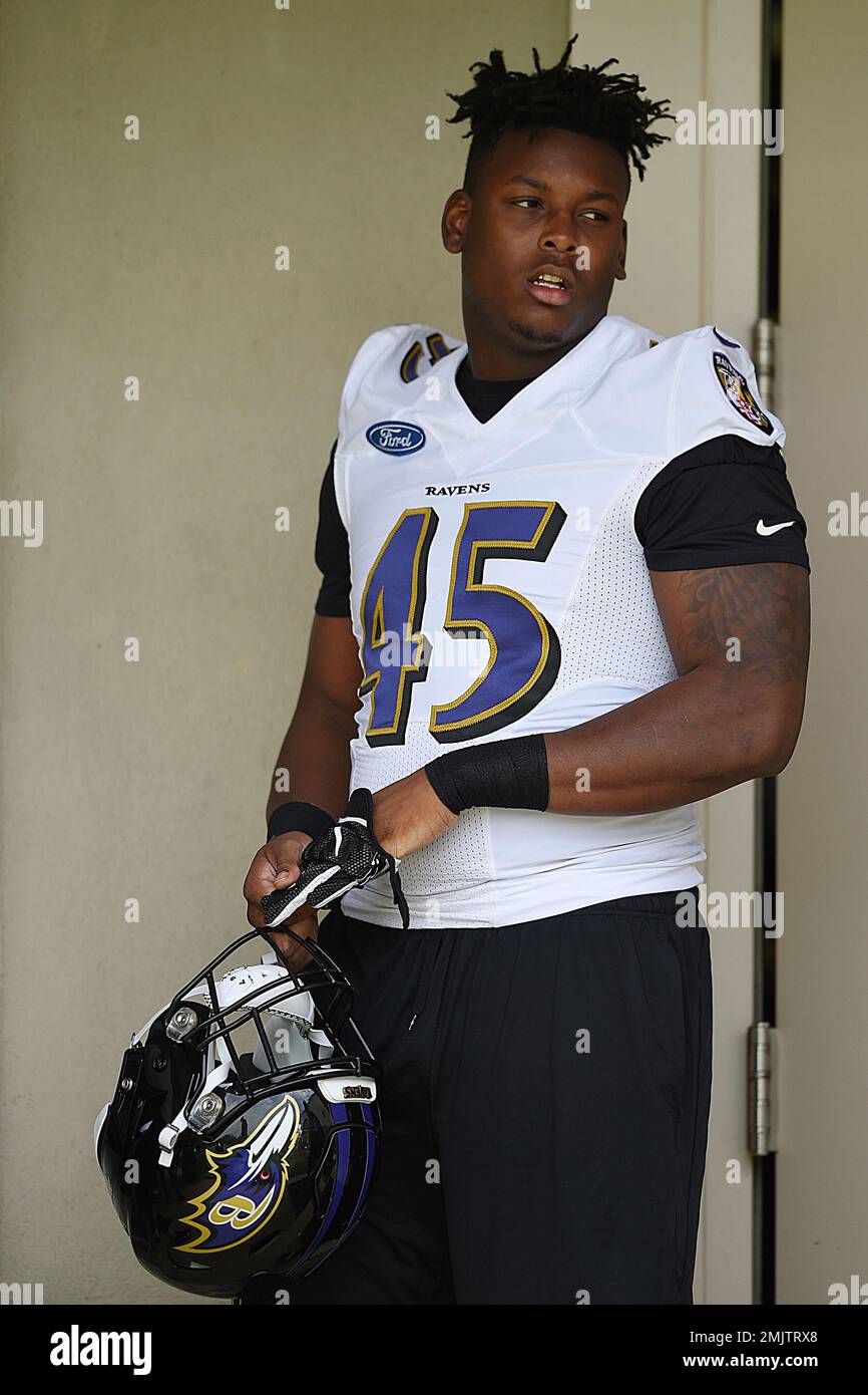 Baltimore Ravens linebacker Jaylon Ferguson stands in the shade before ...