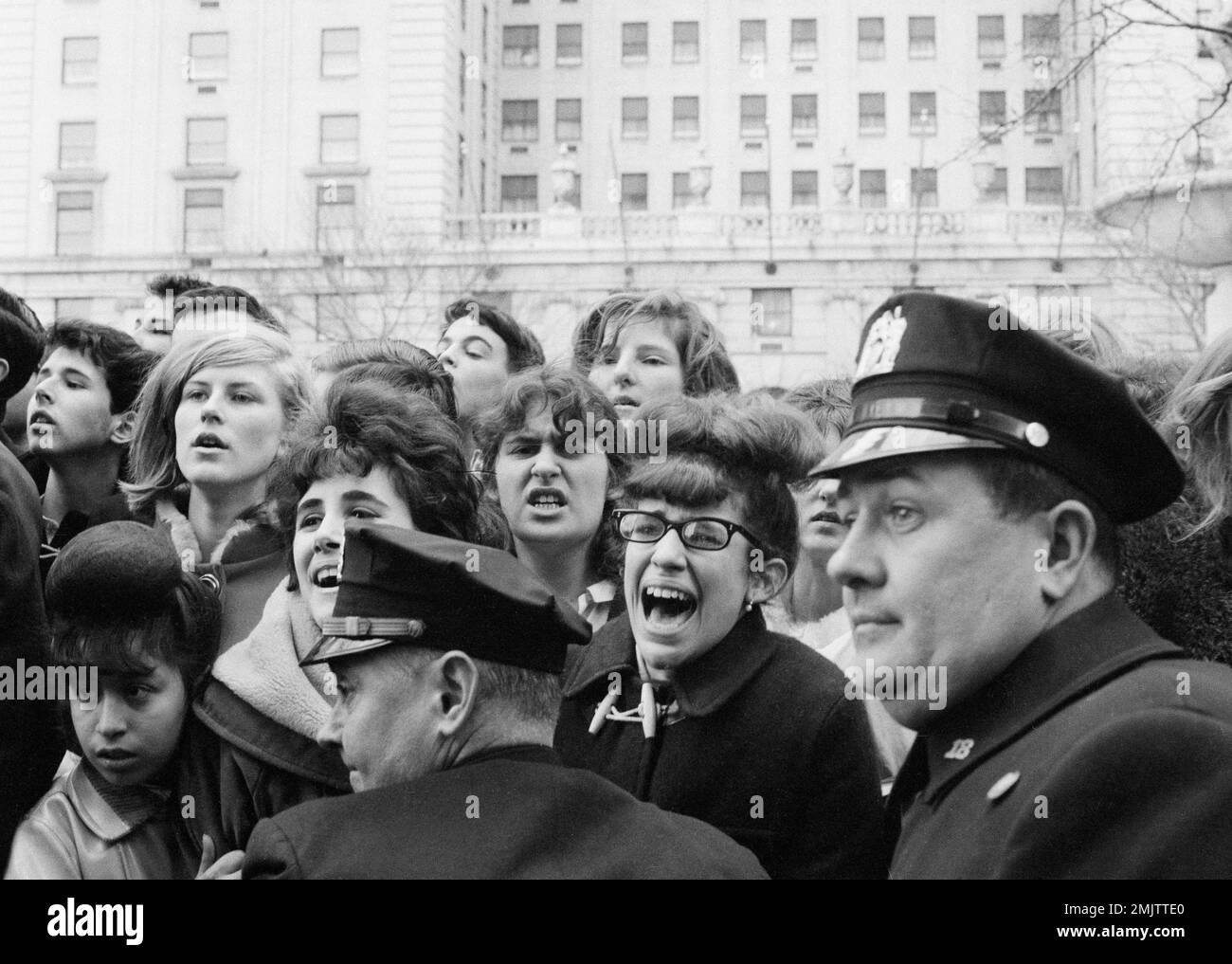 New York City police restrain young Beatles fans intent on mobbing ...