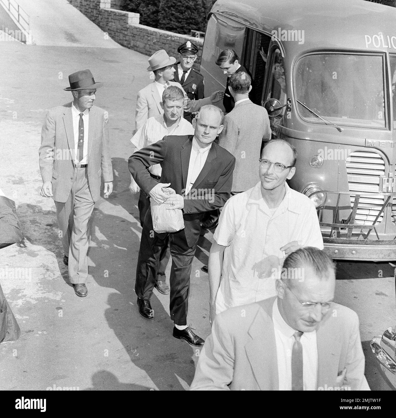 Men held in the bombing early Sunday of the Jewish temple are helped ...