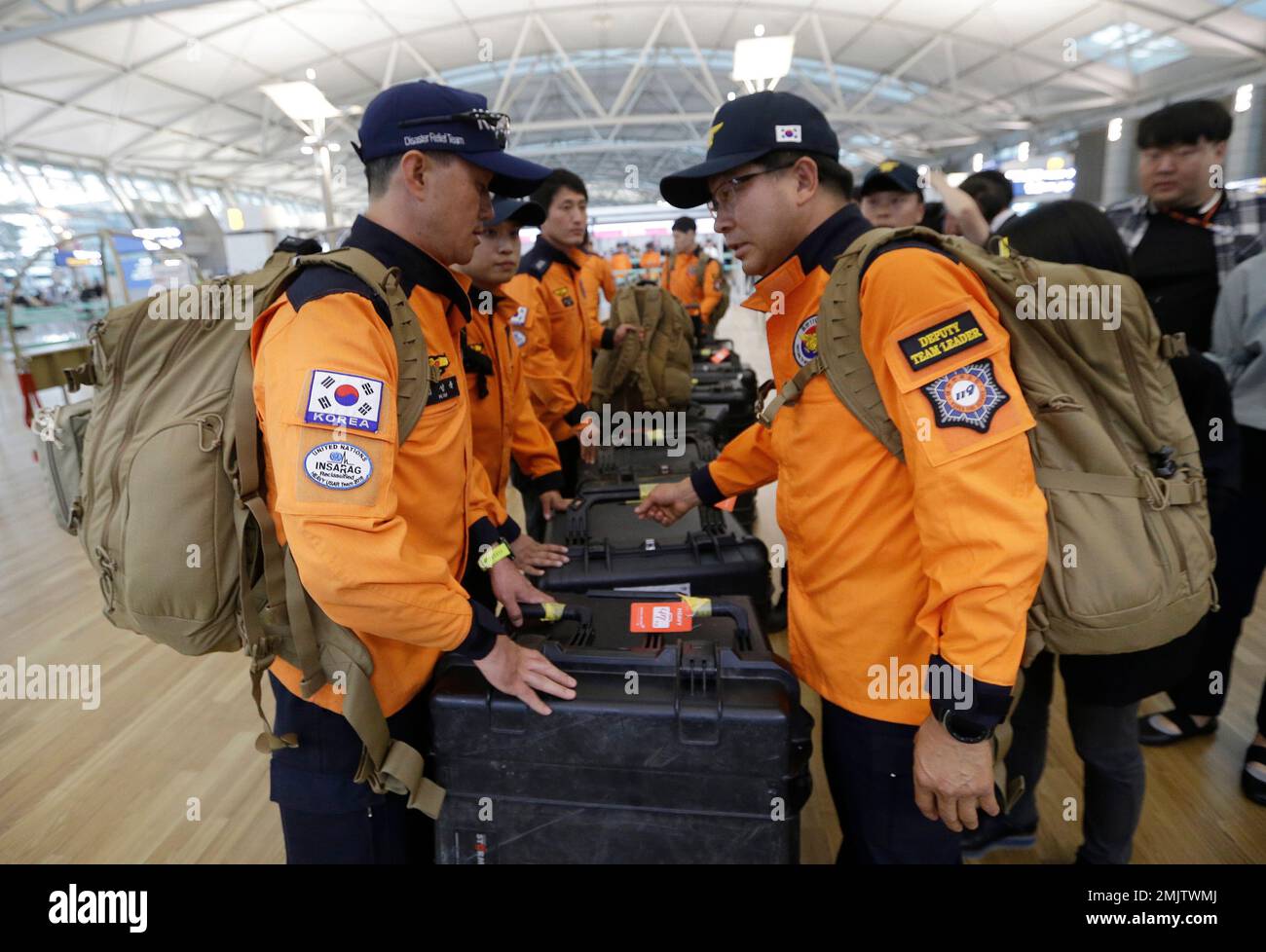 South Korean rescue team members prepare to board a plane to leave for ...