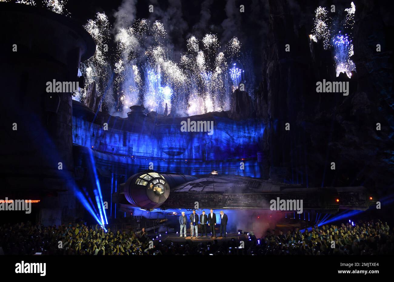 Fireworks go off behind the Millennium Falcon starship during a ...