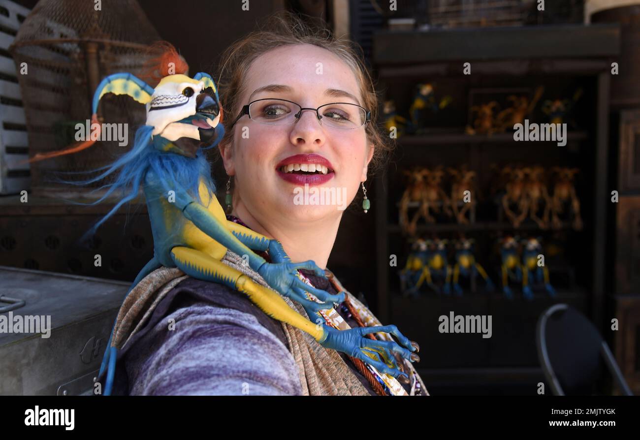 Disneyland employee Julia Millard wears a Kowakian monkey-lizard toy ...