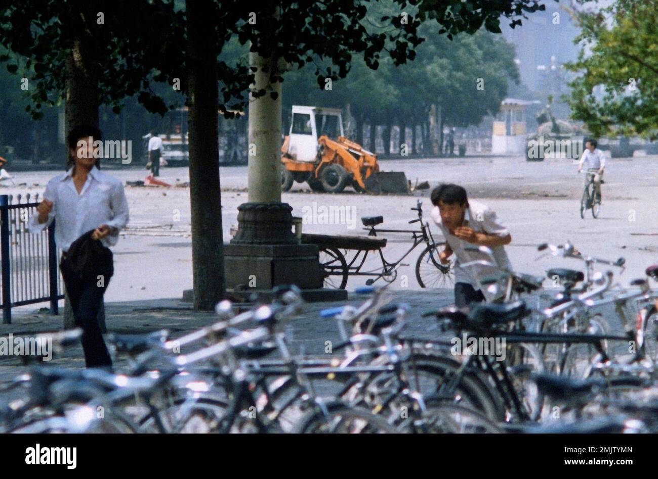 FILE - In this June 5, 1989, file photo, three unidentified men flee ...
