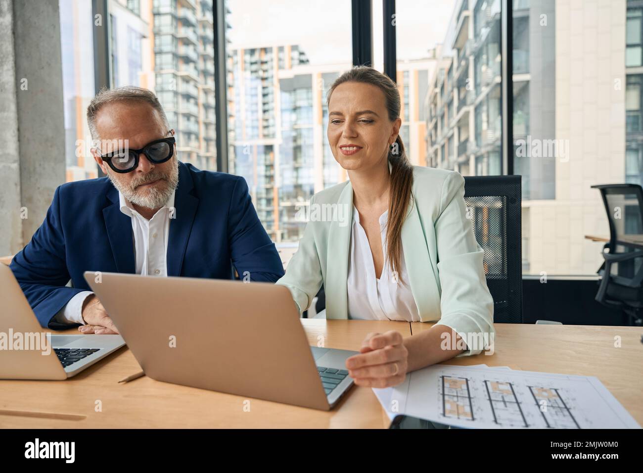 Trusted work partners looking at computer screen at the office Stock ...