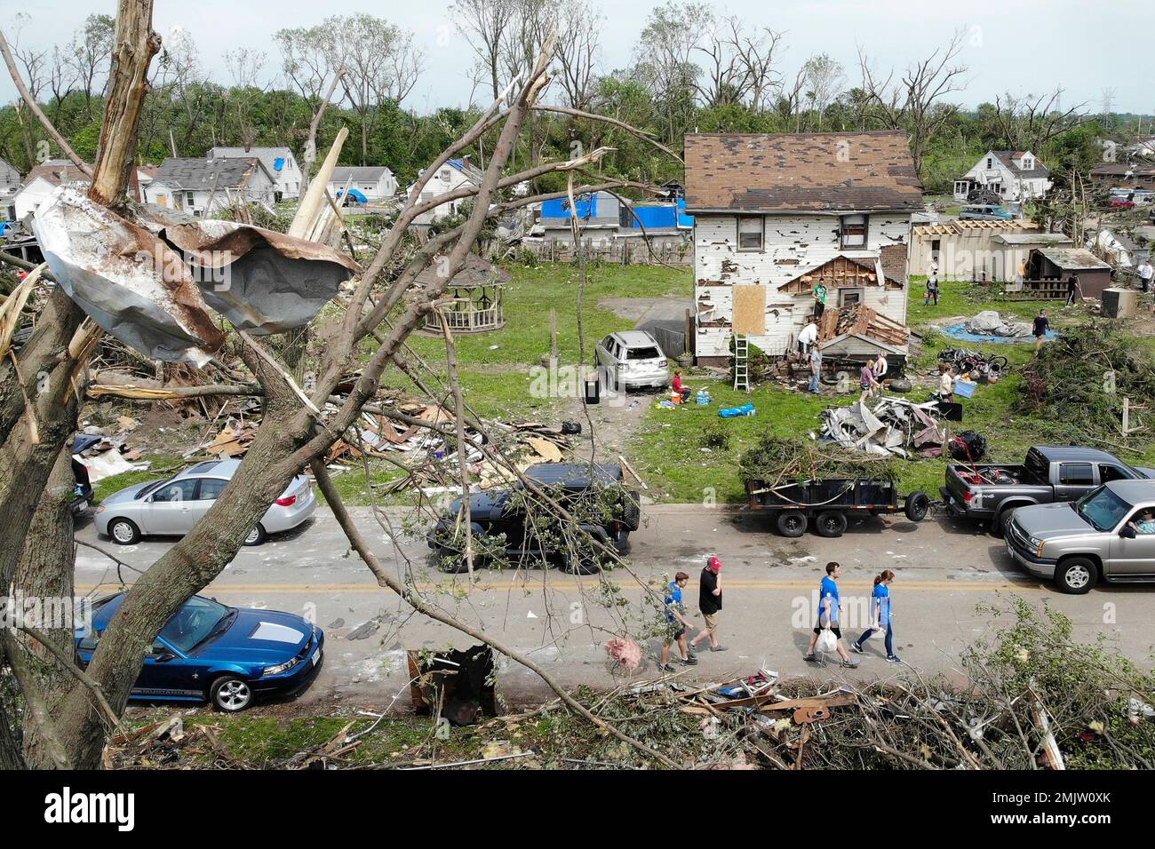 Residents walk through a tornado damaged neighborhood, Wednesday, May 29, 2019, in Dayton, Ohio ...