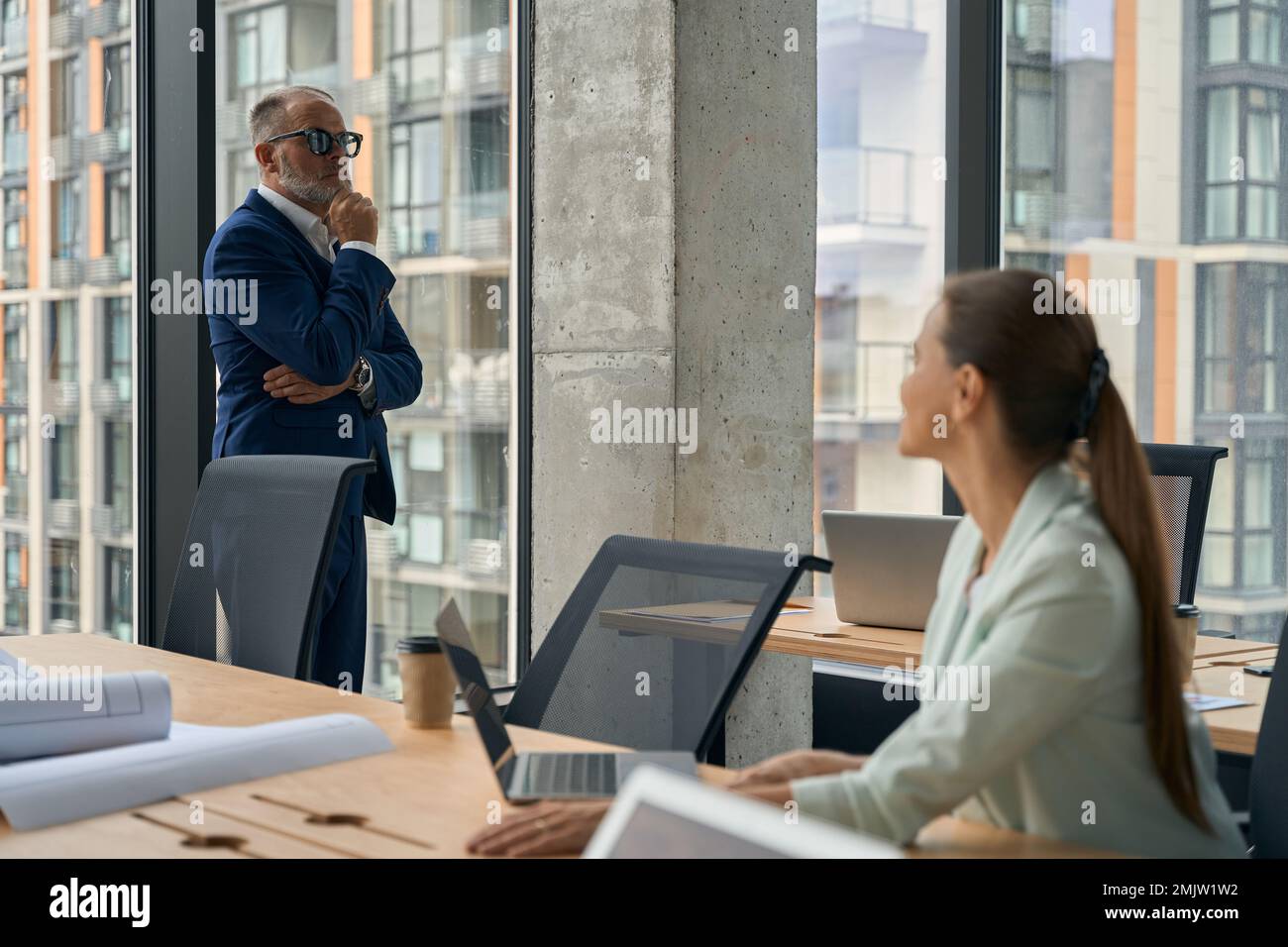 Perplexed office worker thinking hard before making a decision Stock ...