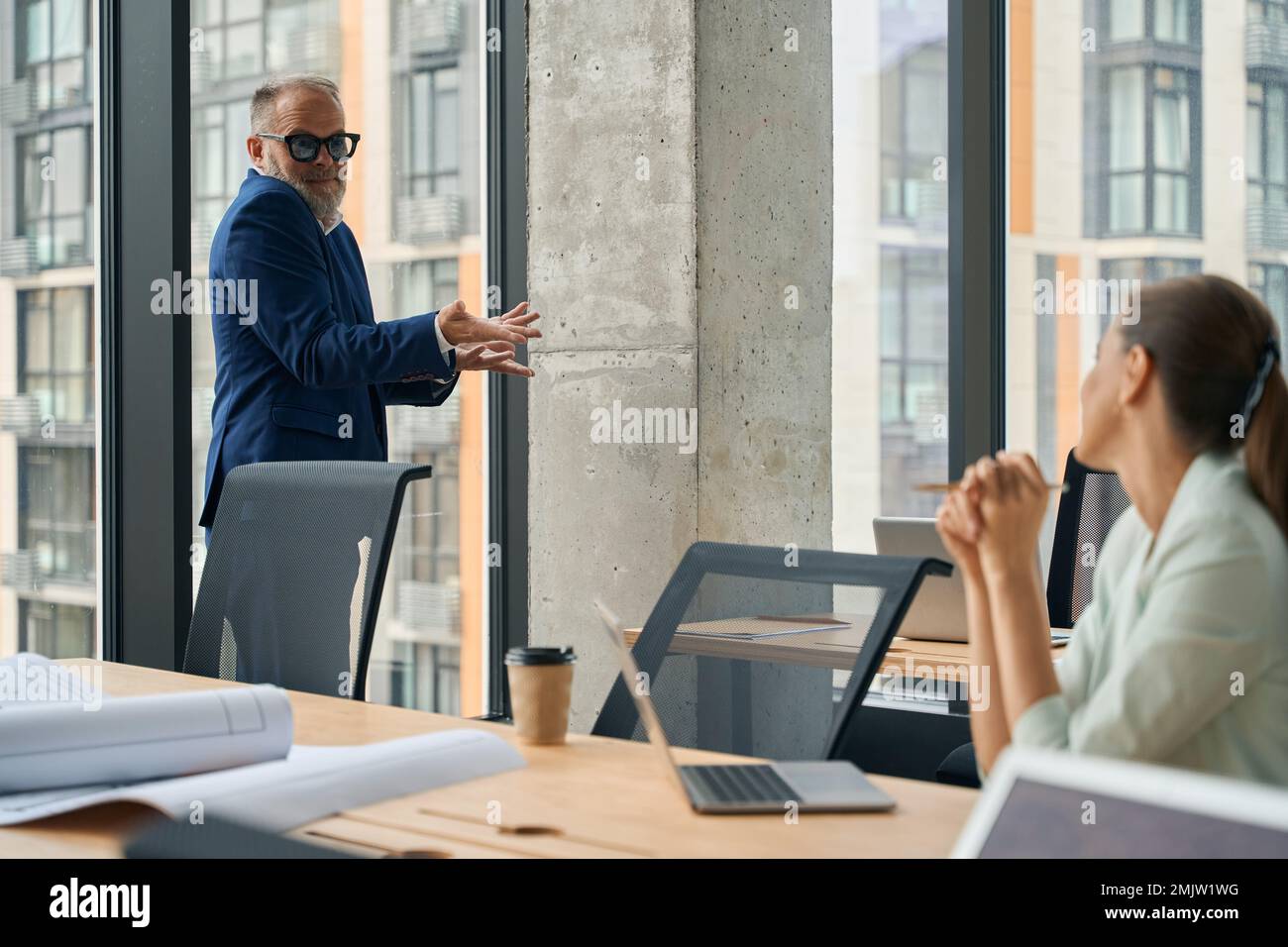 Experienced businessman using body language for communicating with ...