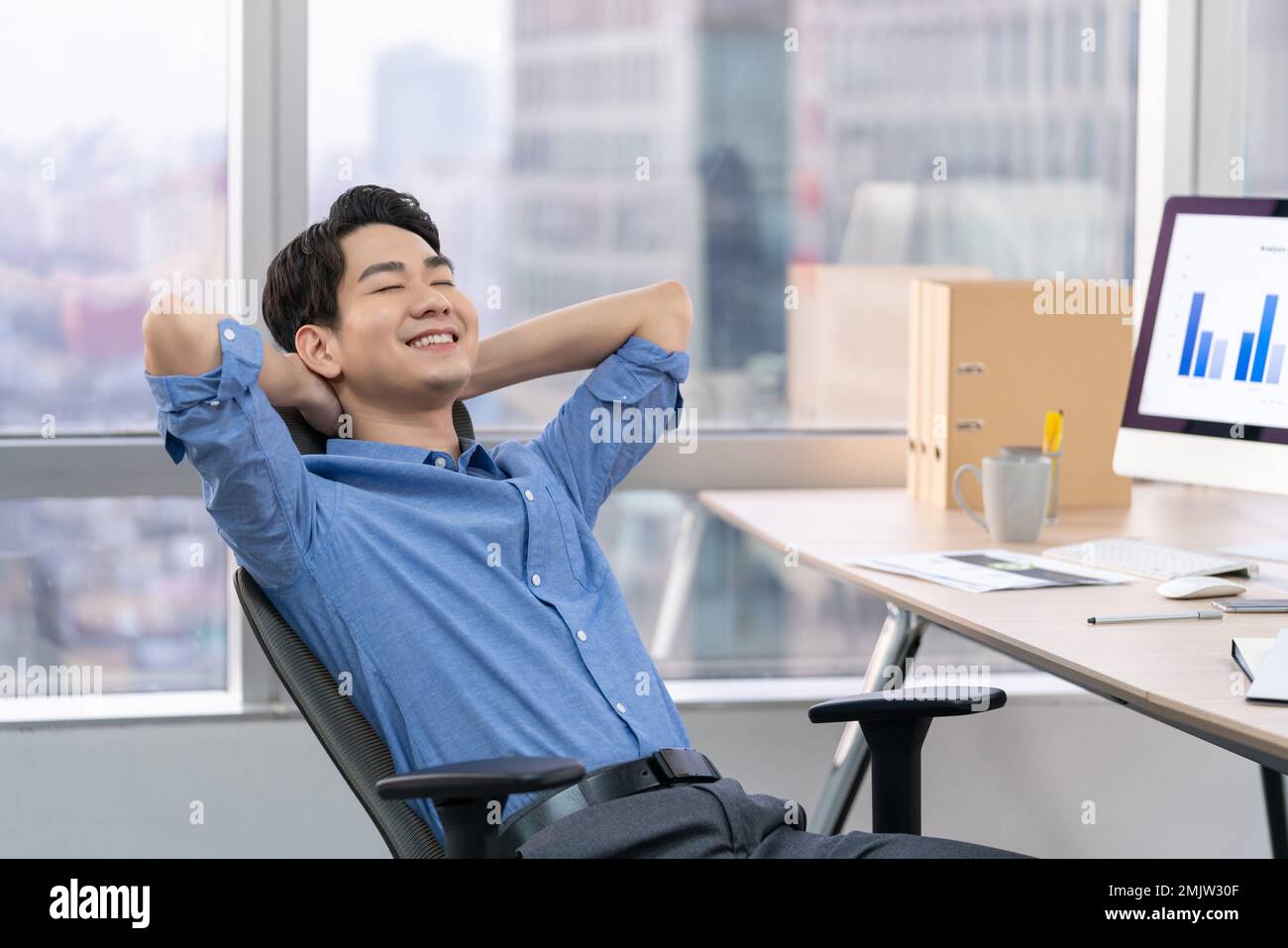 A young business man in the office to rest Stock Photo - Alamy