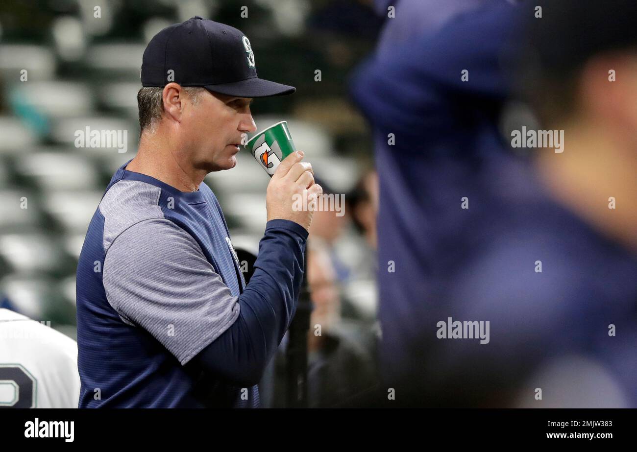 Seattle Mariners manager Scott Servais sips from a cup in the late ...