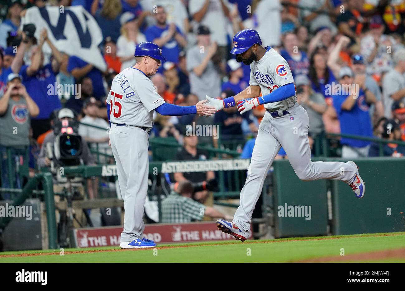 Chicago Cubs' Jason Heyward (22) celebrates with third base coach Brian ...