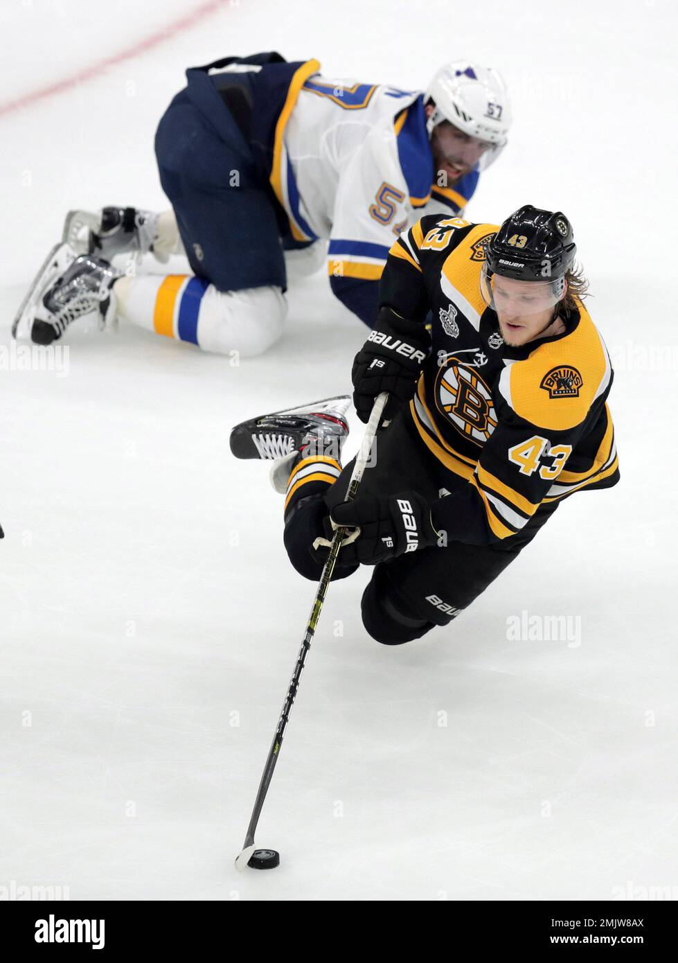 Boston Bruins' Danton Heinen (43) carries the puck in front of St ...