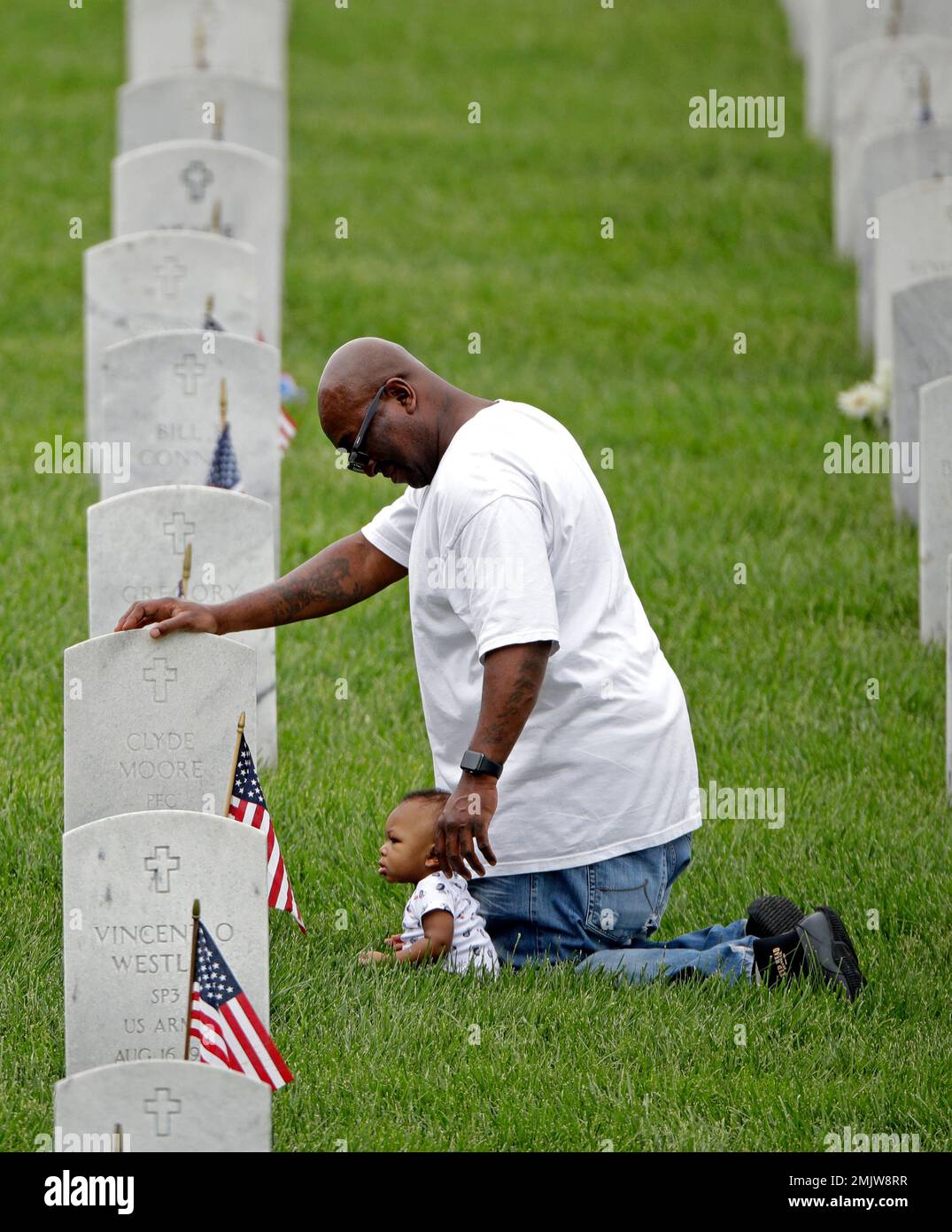 Craig Moore, with his 8-month-old son Craig Moore, Jr. visits his ...