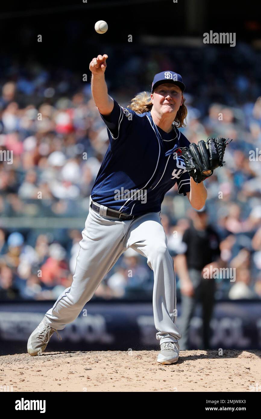 San Diego Padres relief pitcher Trey Wingenter throws to first base ...