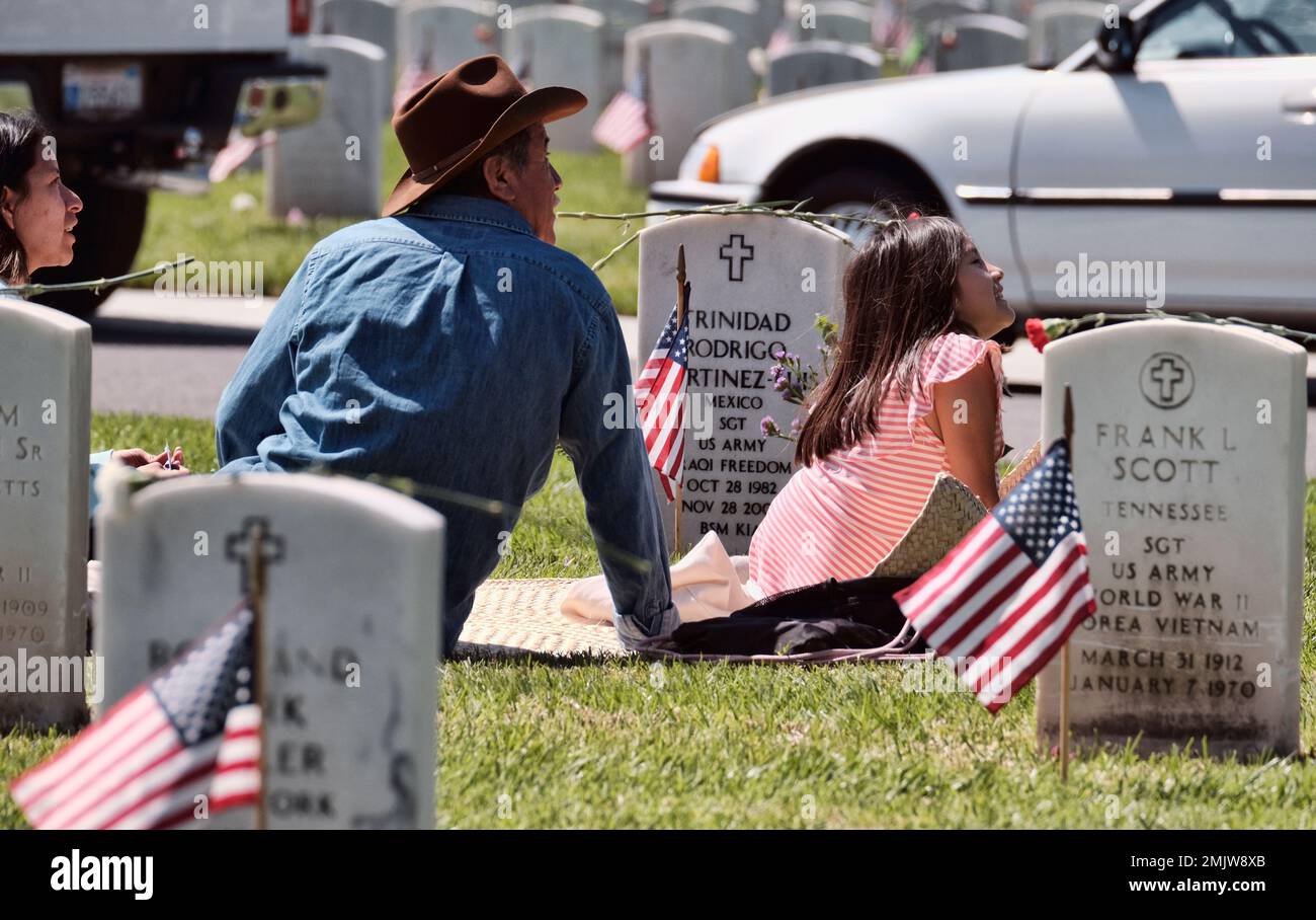 Solomon Martinez, center, with his family watch a flyover while paying ...