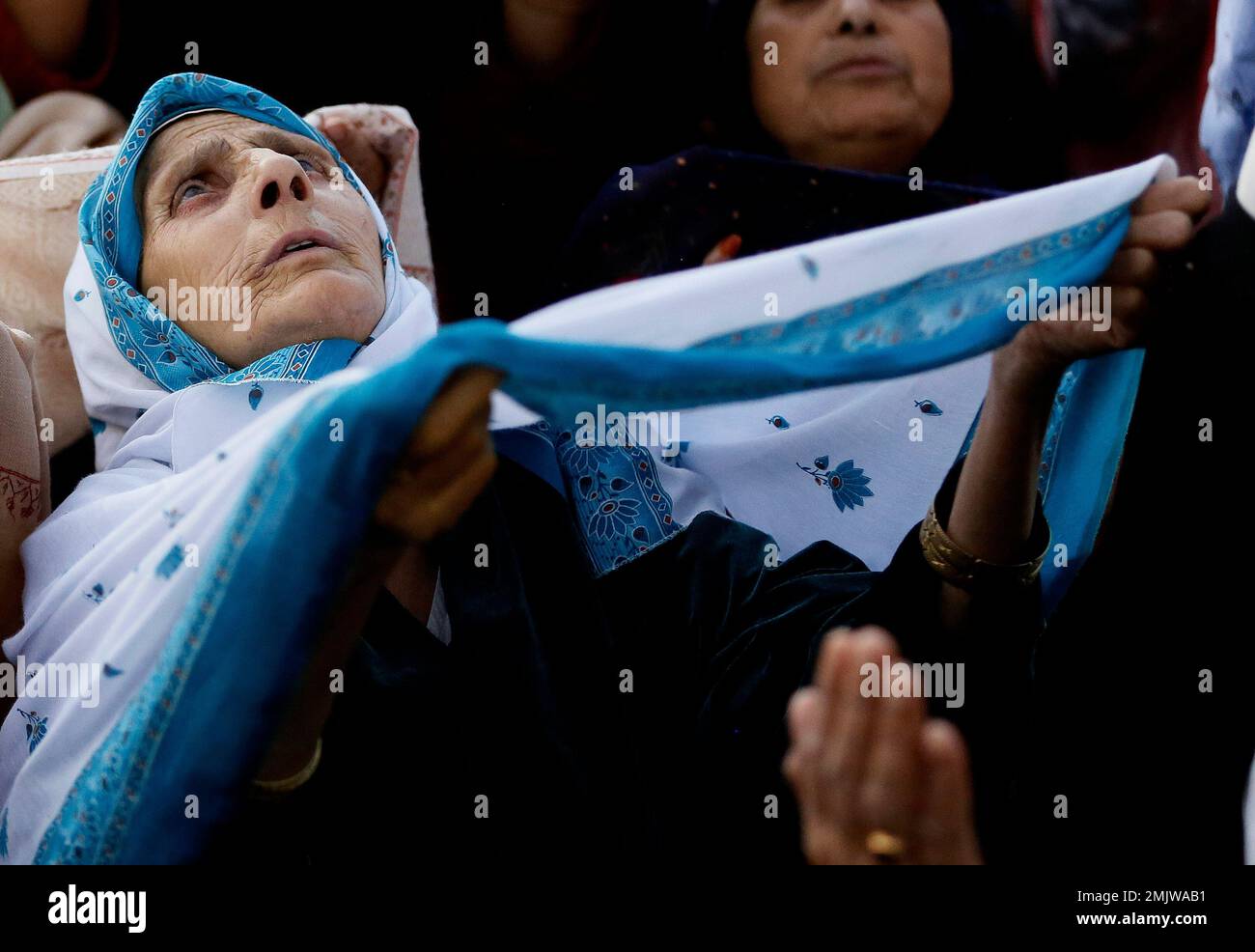 Kashmiri Muslim devotees pray as a head priest displays a relic ...