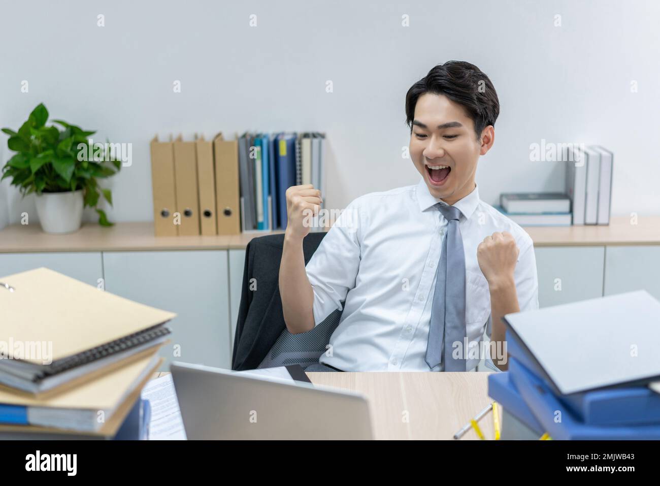 Happy business men in the office to work overtime Stock Photo - Alamy