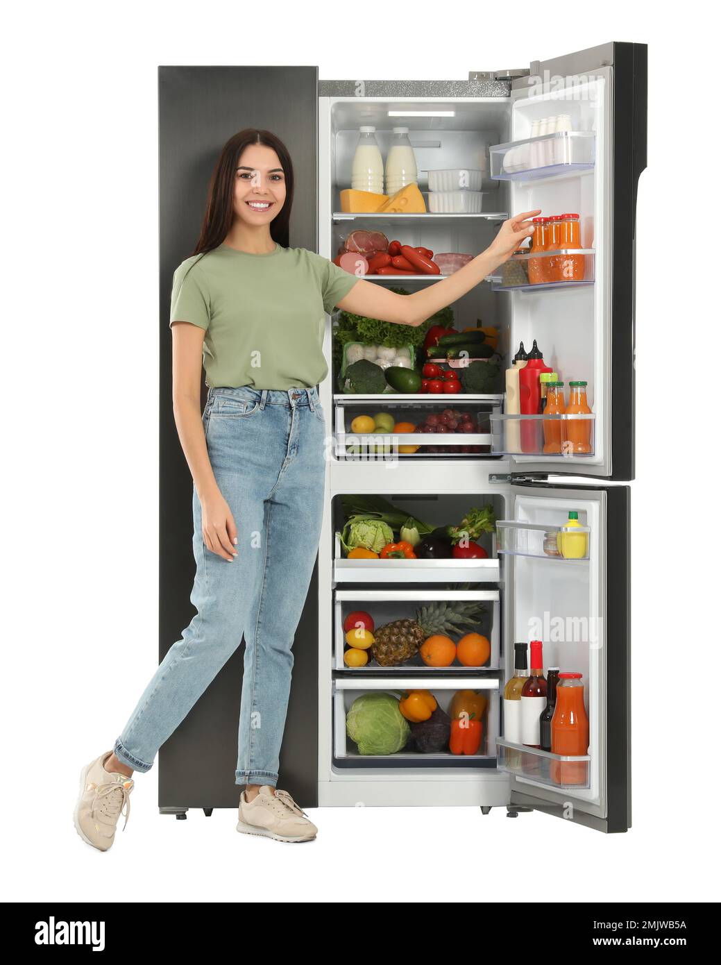 Young woman taking juice from refrigerator on white background Stock ...