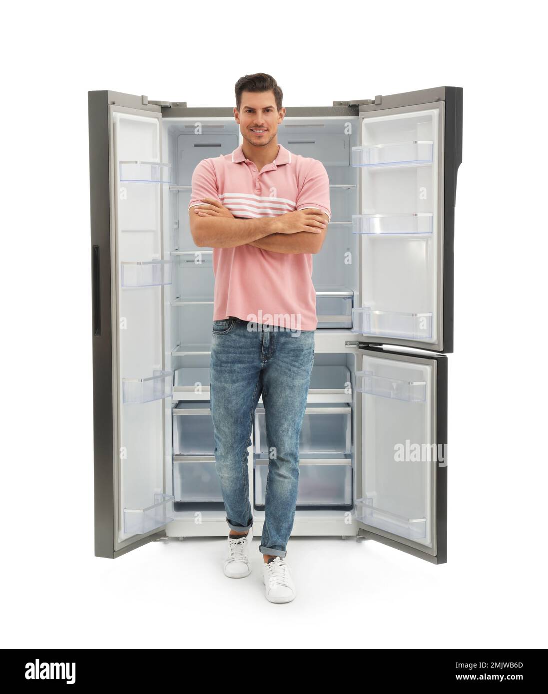 Man near empty refrigerator on white background Stock Photo - Alamy