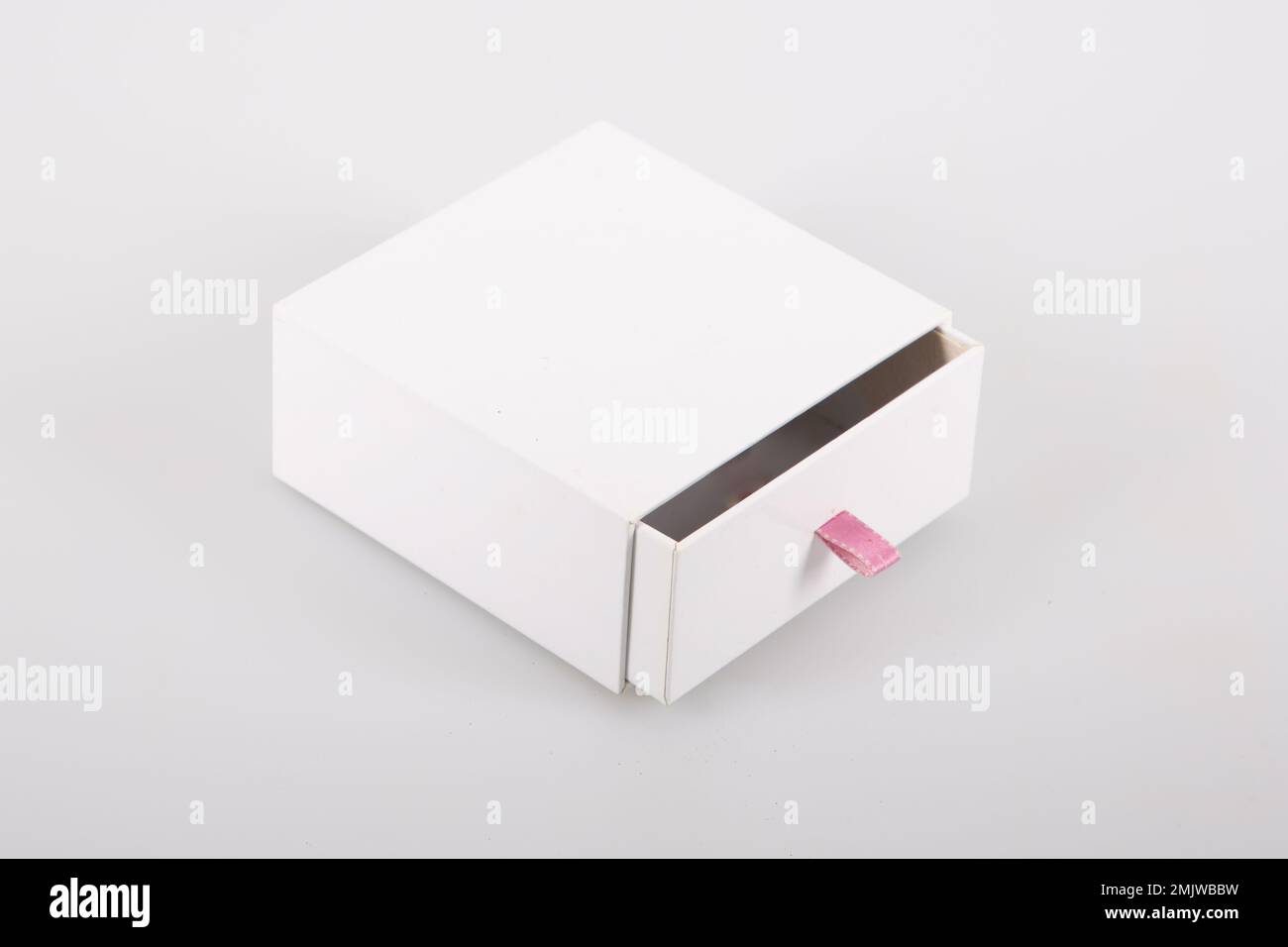 Opened cardboard sliding box with drawer pink ribbon Stock Photo - Alamy