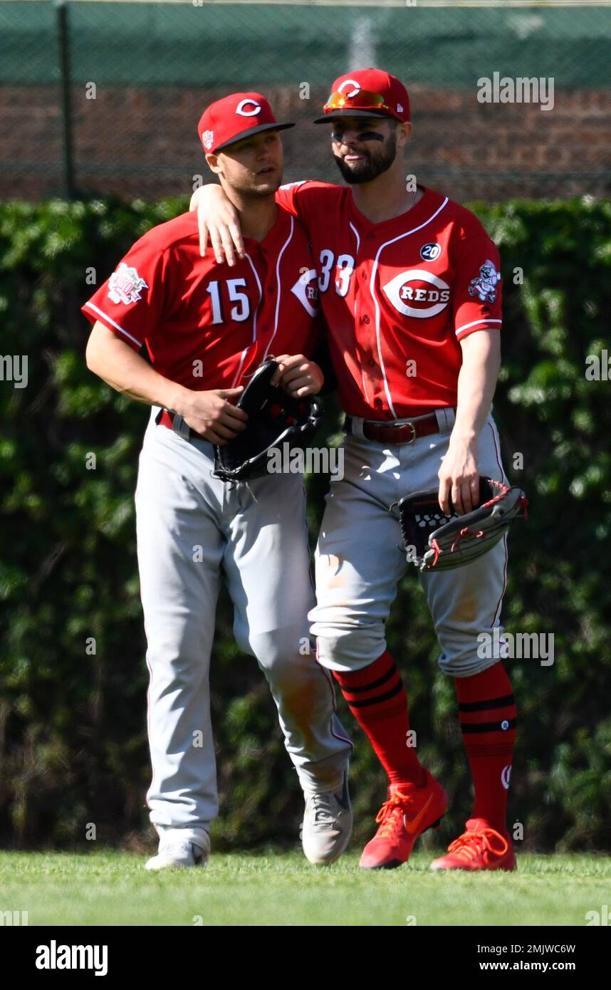 Cincinnati Reds right fielder Jesse Winker (33) and center fielder Nick ...