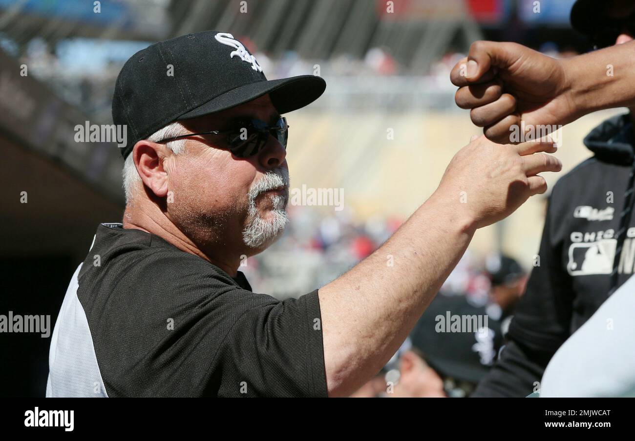 Chicago White Sox manager Rick Renteria fist-bumps a player coming off ...