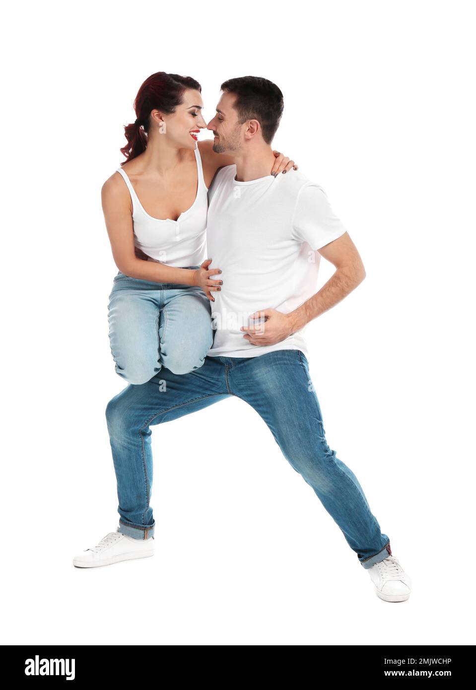 Beautiful young couple dancing on white background Stock Photo - Alamy
