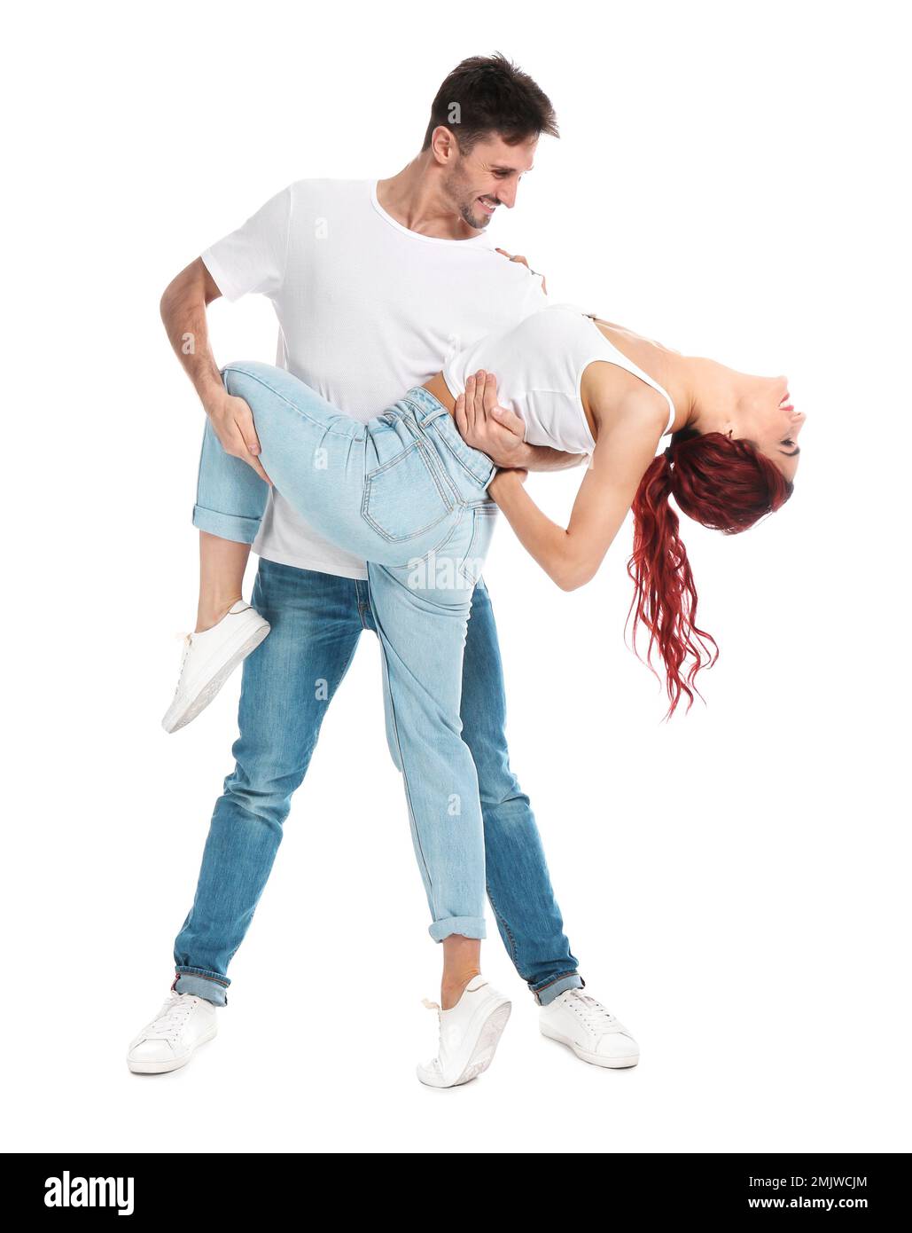 Beautiful young couple dancing on white background Stock Photo - Alamy