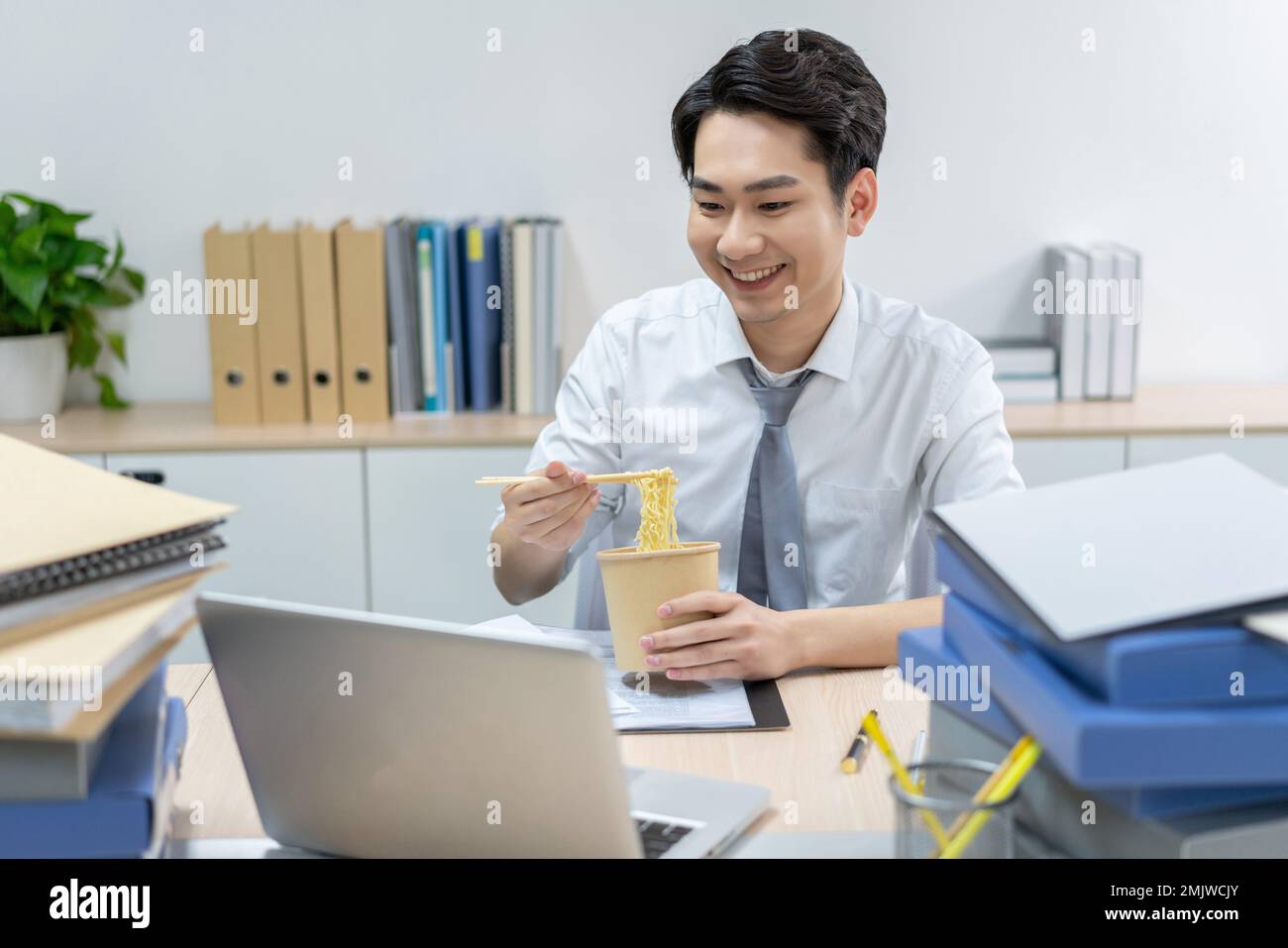 Happy business men in the office to work overtime Stock Photo - Alamy