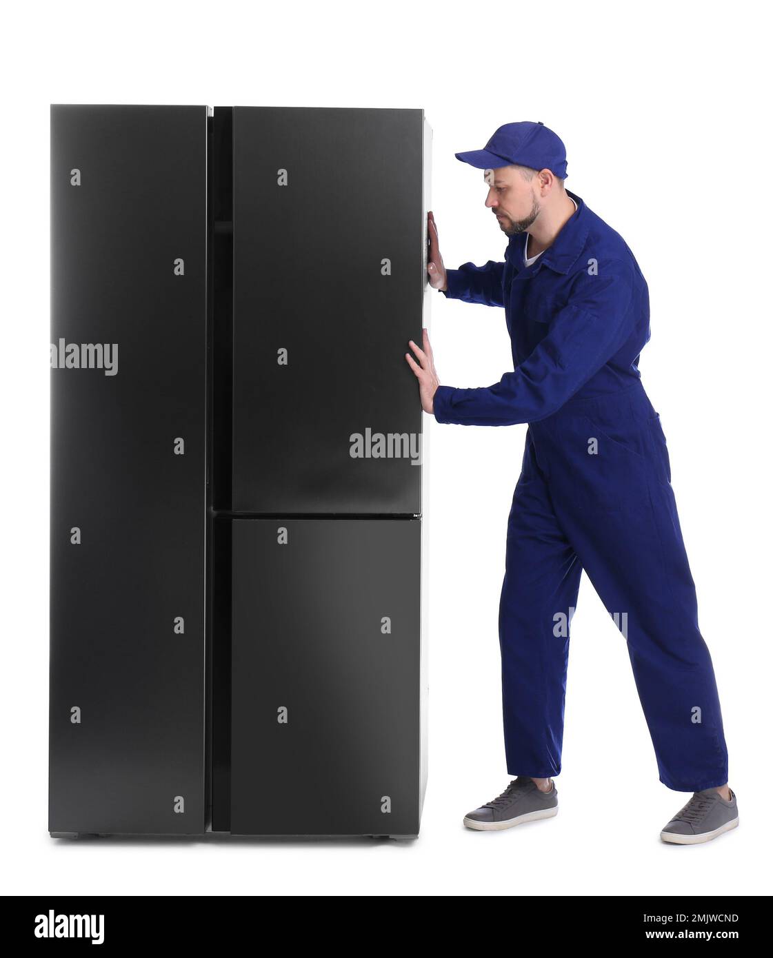 Professional worker carrying refrigerator on white background Stock ...
