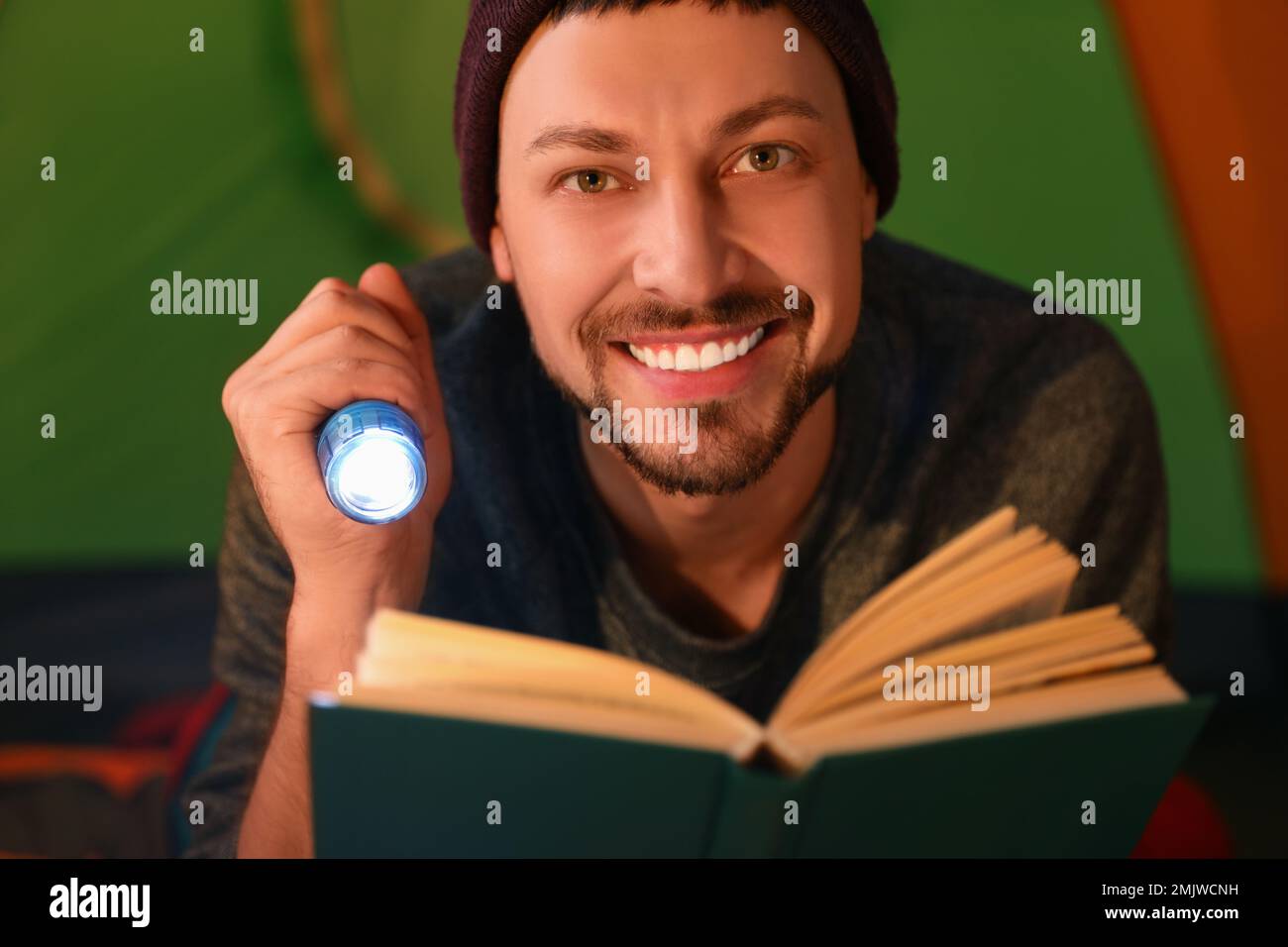 Man flashlight reading book hi-res stock photography and images - Alamy