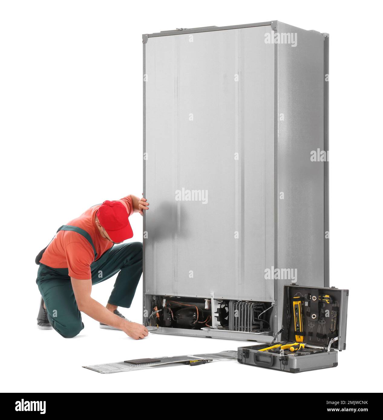 Male technician repairing refrigerator on white background Stock Photo ...