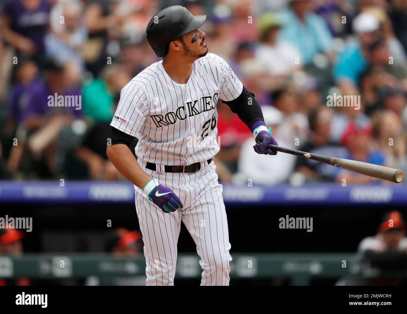 Colorado Rockies' Nolan Arenado follows the flight of his two-run home ...
