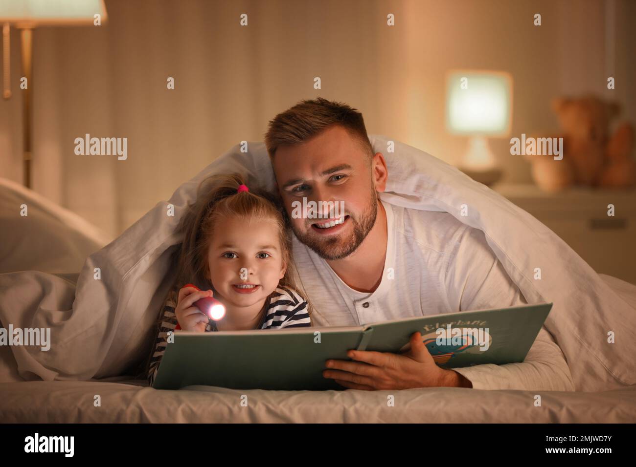 Child parent reading flashlight hi-res stock photography and images - Alamy