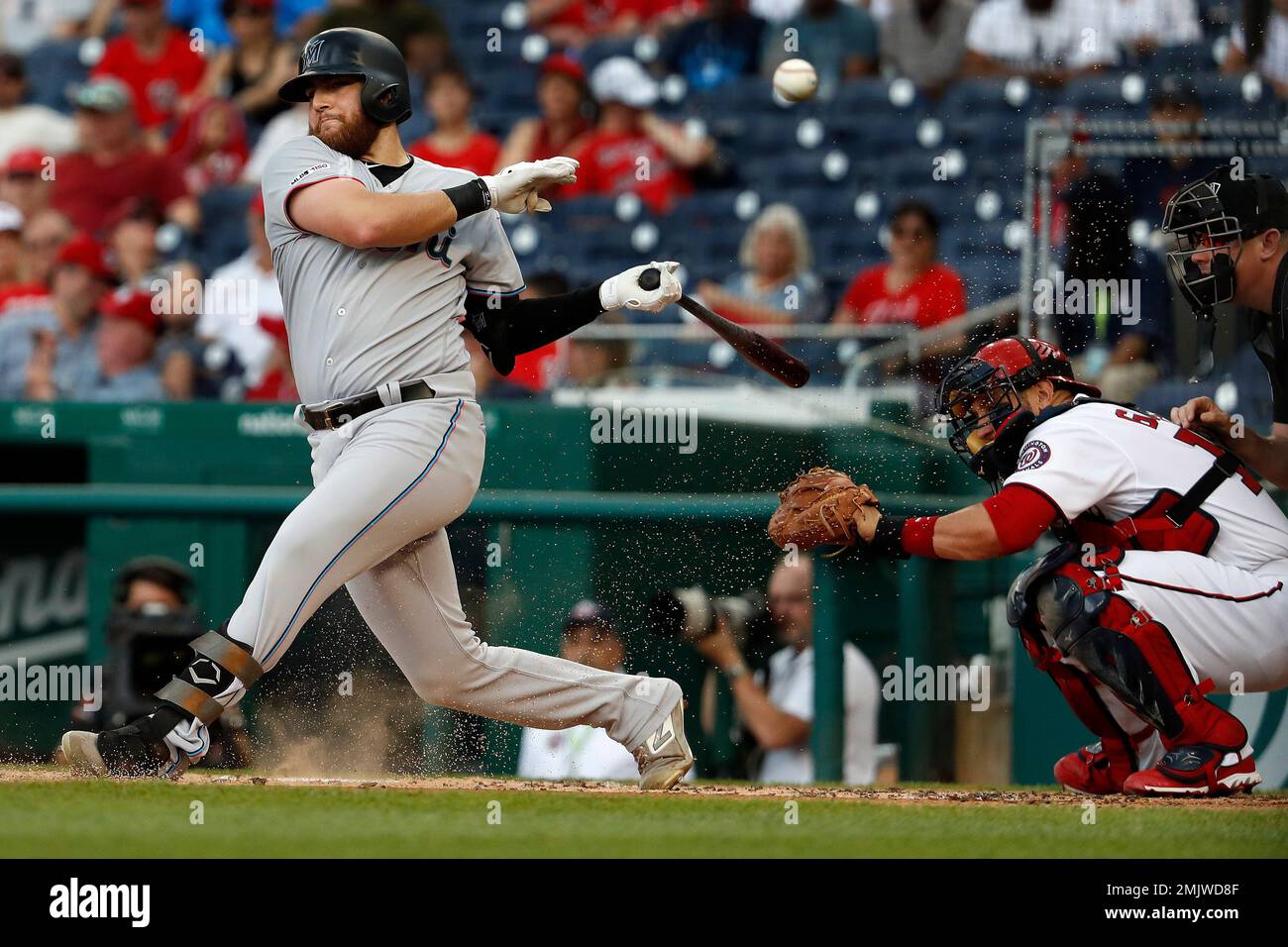 Miami Marlins' Austin Dean (44), next to Washington Nationals catcher ...